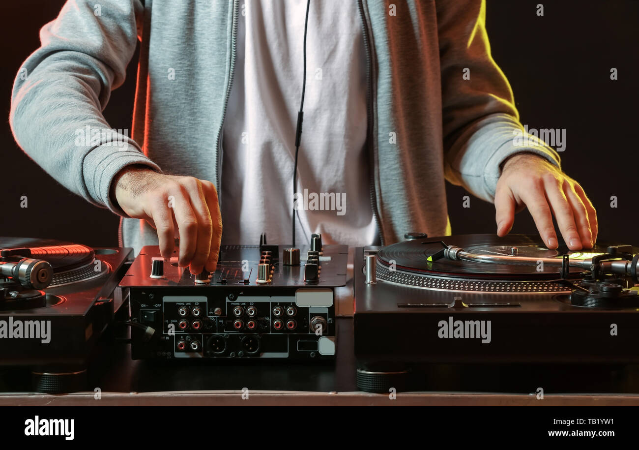 Male DJ playing music in club Stock Photo - Alamy