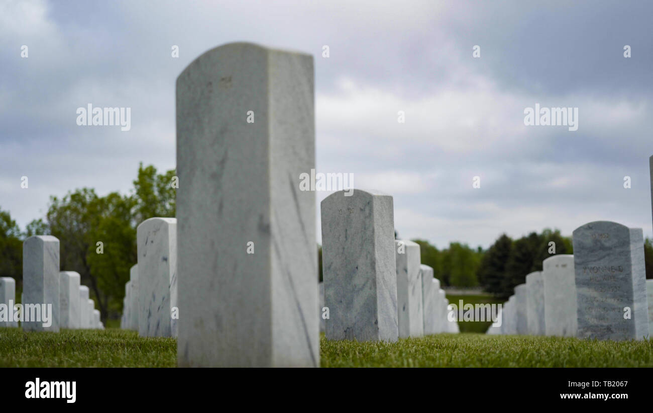 An endless rows of white marble gravestones at the Fort Logan National ...