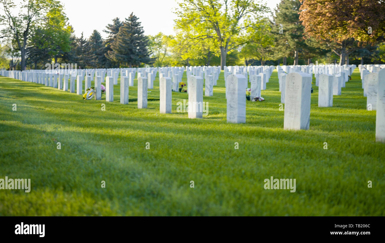 An endless rows of white marble gravestones at the Fort Logan National ...