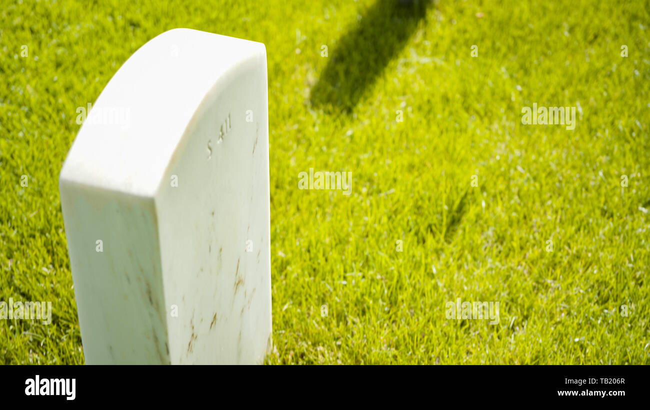 An endless rows of white marble gravestones at the Fort Logan National ...