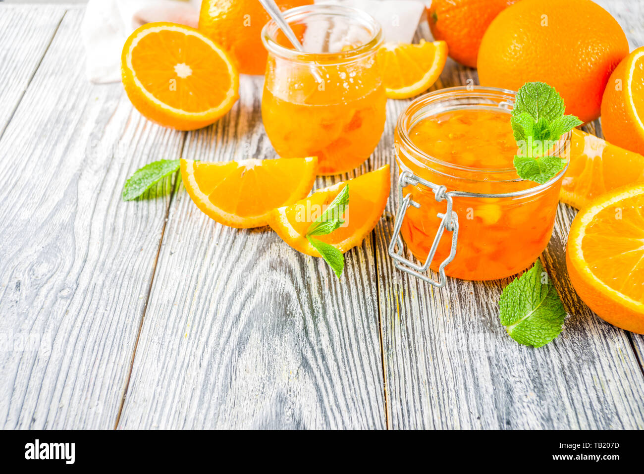 Homemade orange jam, with fresh sliced oranges and mint leaves, white ...