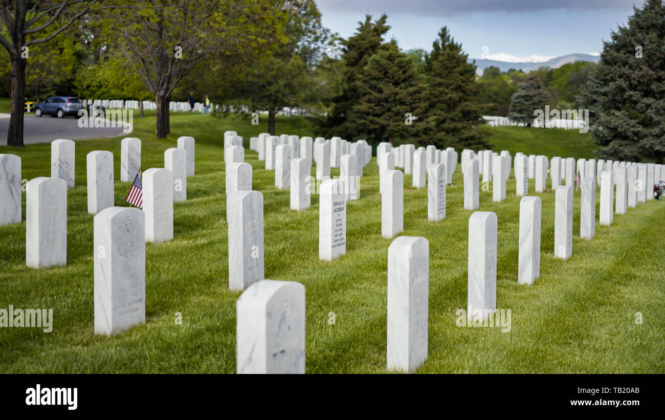 An endless rows of white marble gravestones at the Fort Logan National ...