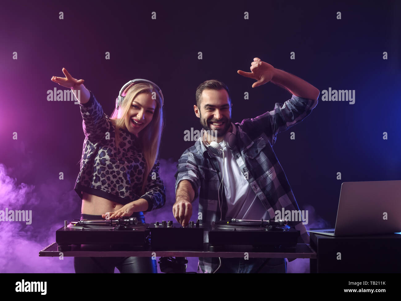 Male and female DJs playing music in club Stock Photo - Alamy