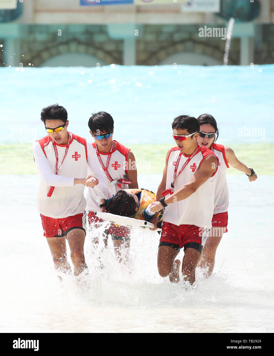 30th May, 2019. Rescue drill at water park Lifeguards carry a simulated ...