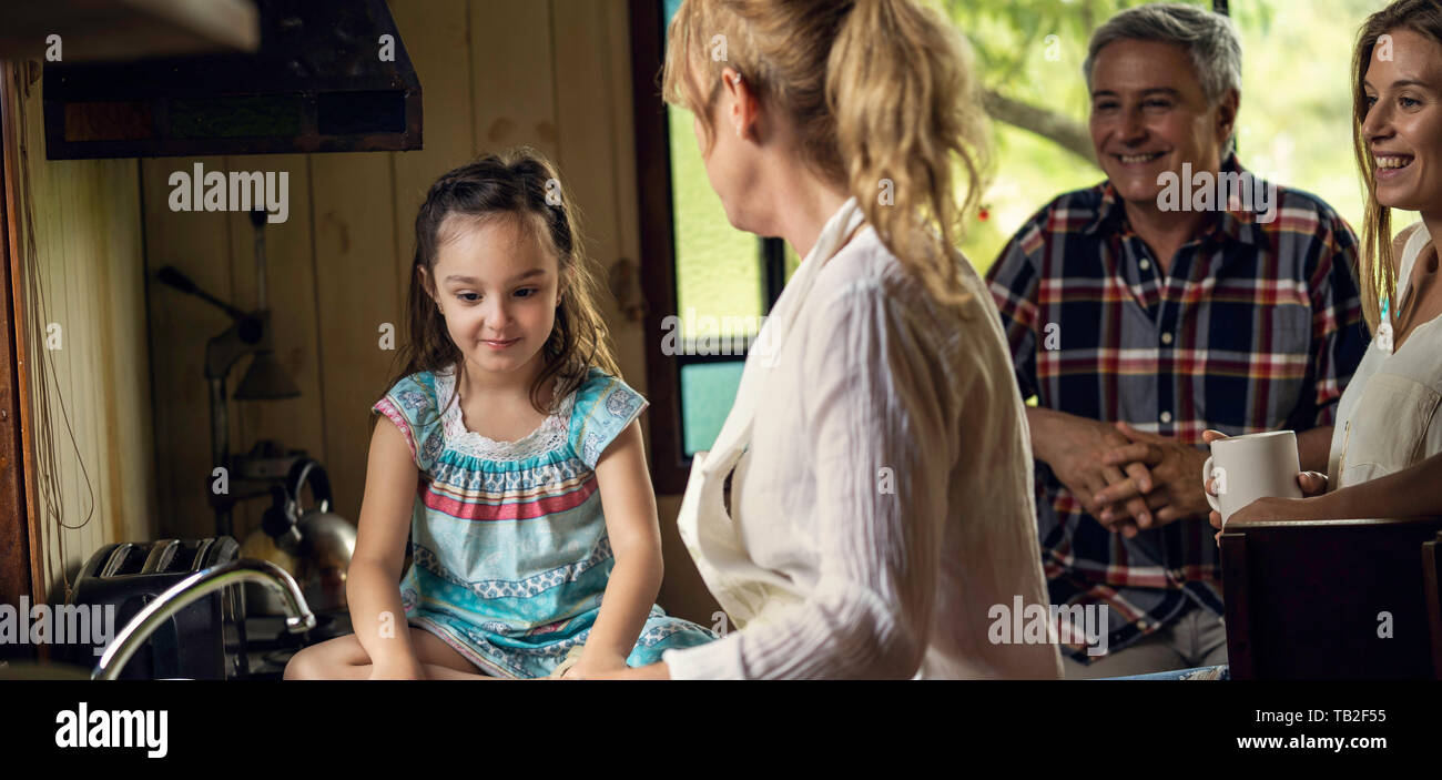 Family talking in kitchen Stock Photo - Alamy