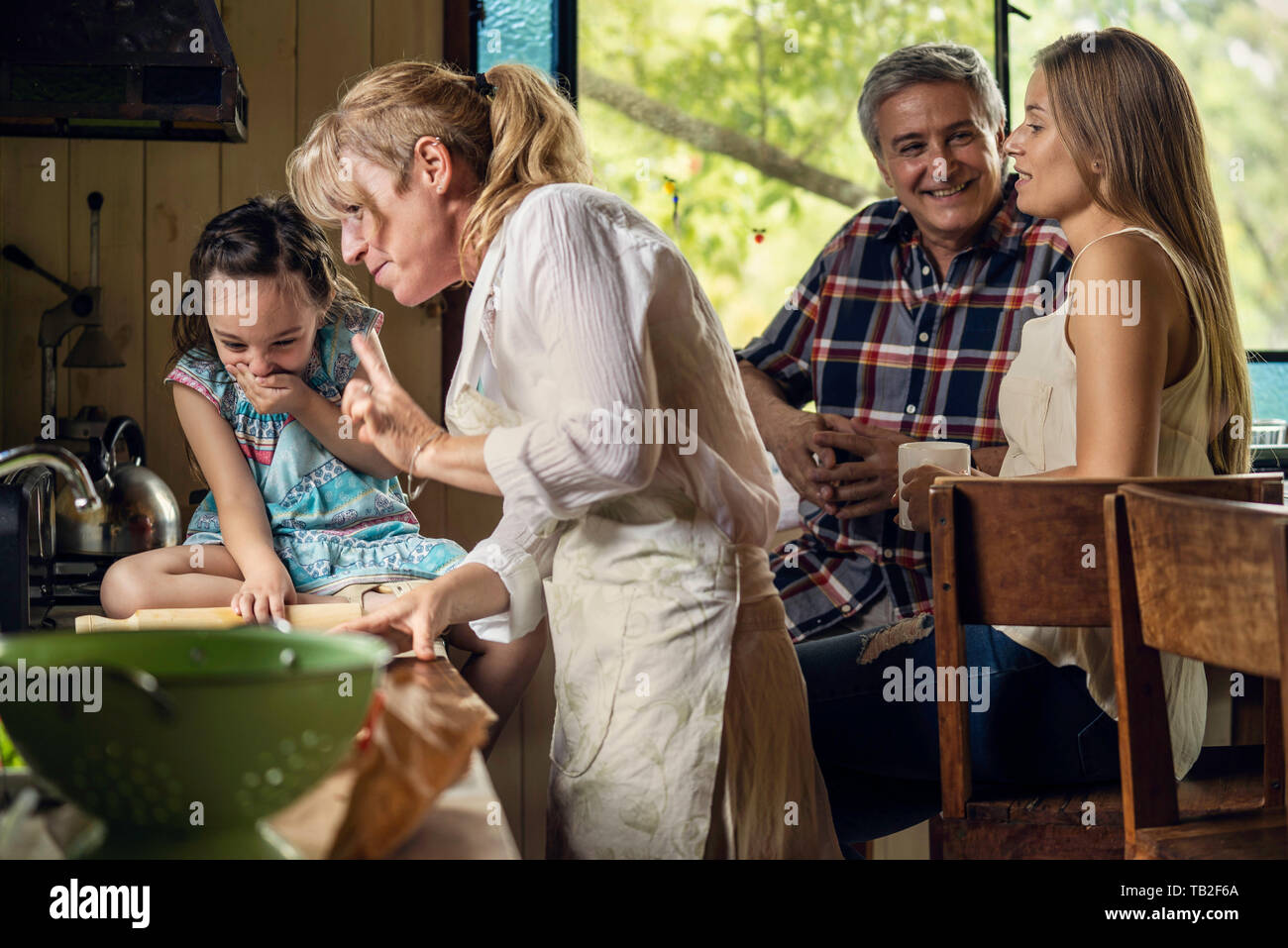 Family talking in kitchen Stock Photo - Alamy