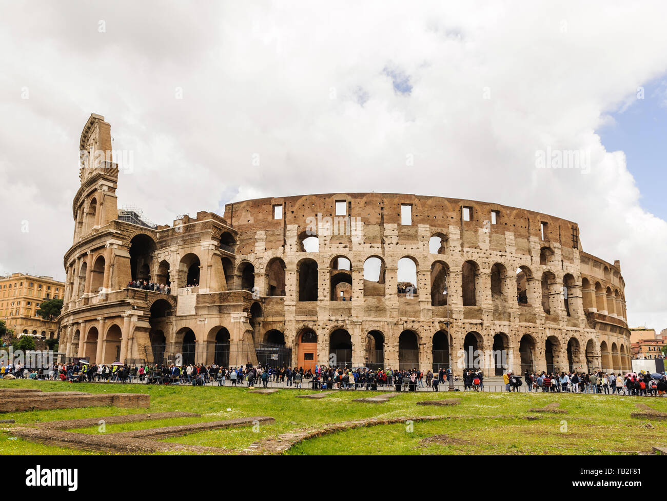 A view of the Coliseum surrounded by a crowd of tourists wishing to get ...