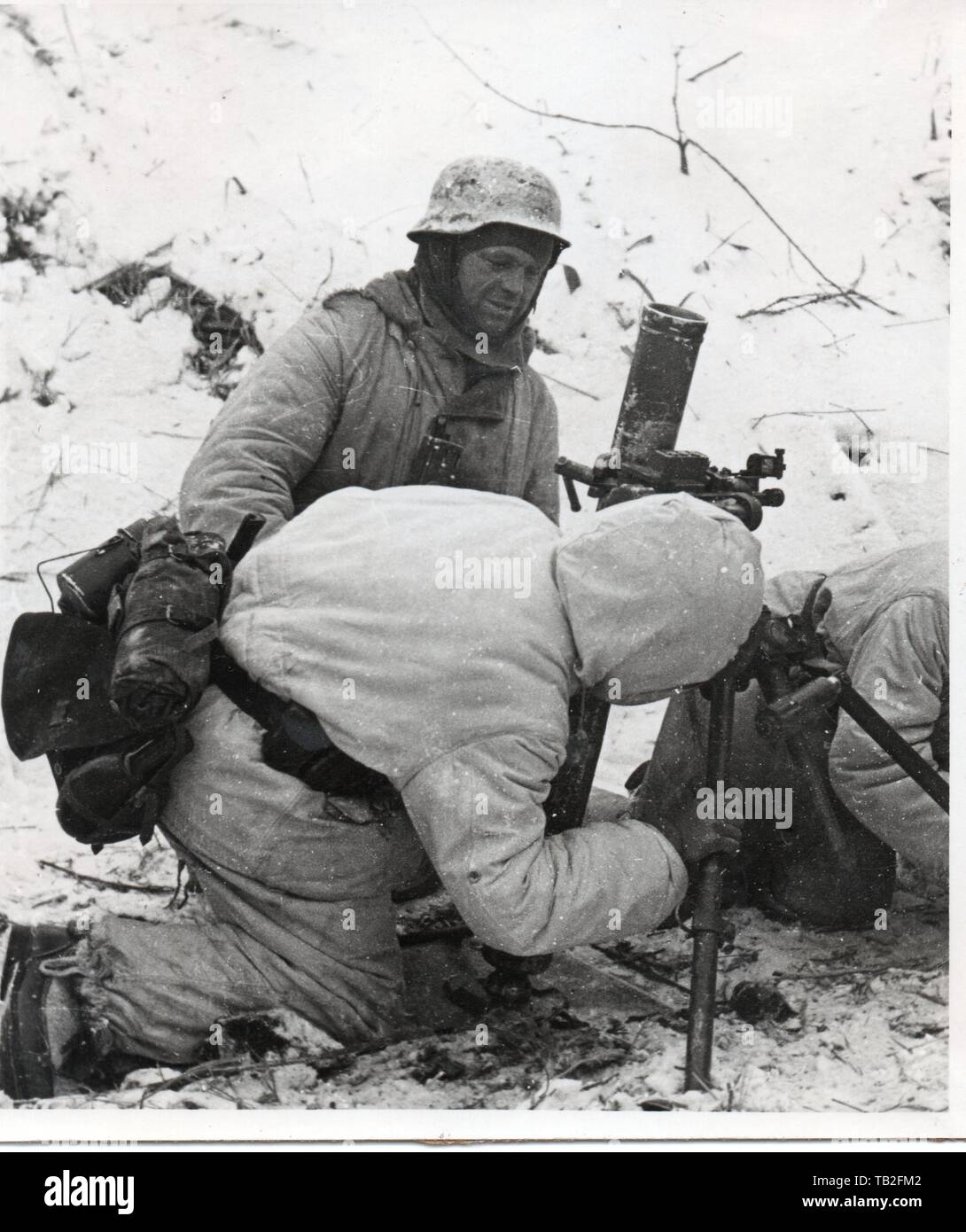 German soldiers duck down as they fire a mortar hi-res stock ...
