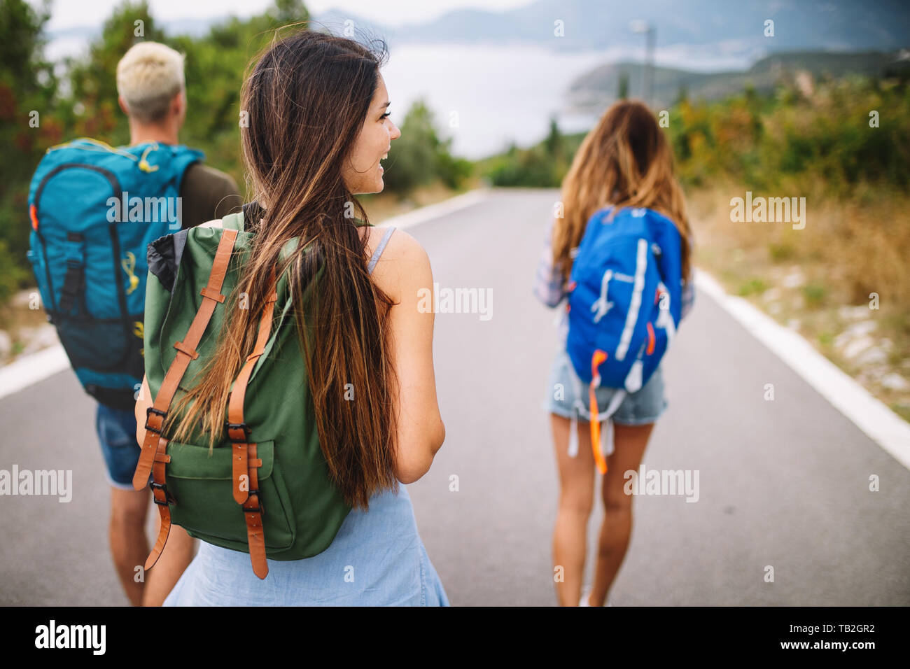 Group of friends backpackers walking and traveling outdoor Stock Photo ...