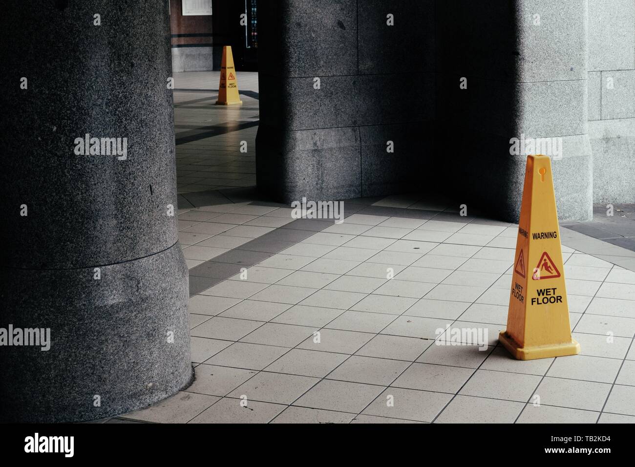 Caution slippery surface cone sign hi-res stock photography and images ...