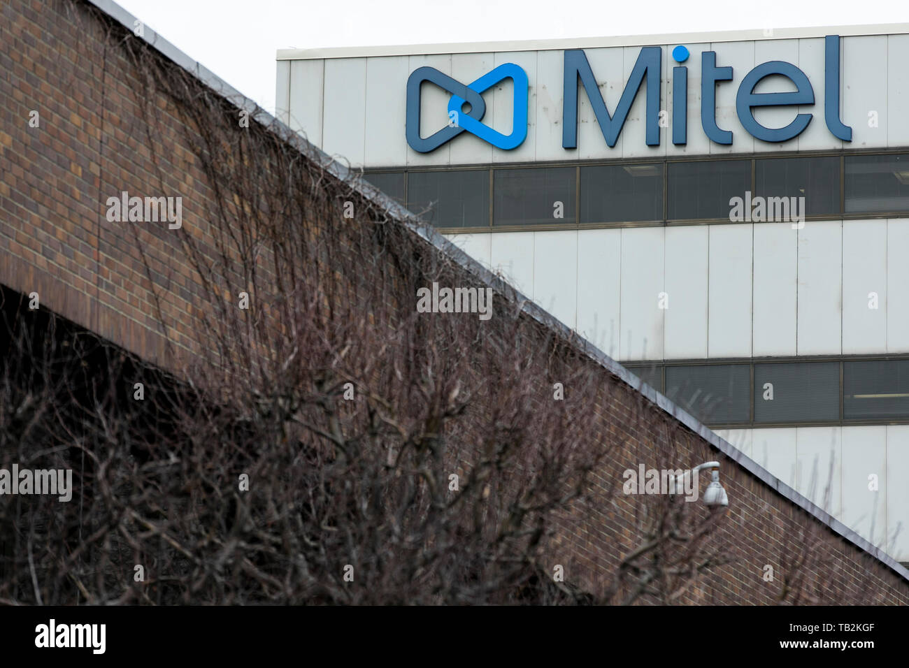 A logo sign outside of the headquarters of the Mitel Networks ...