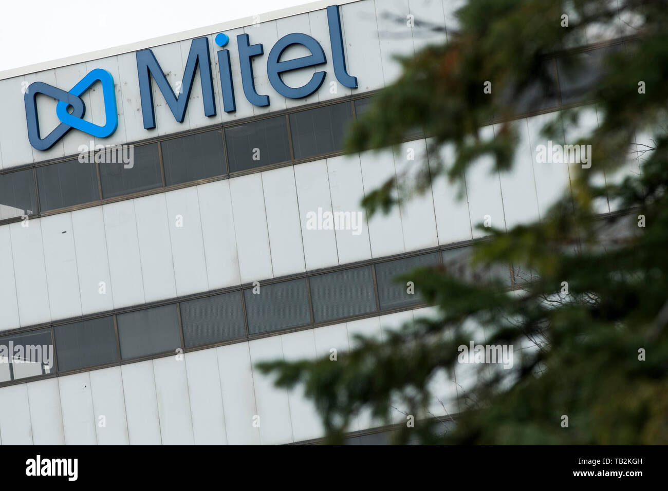 A logo sign outside of the headquarters of the Mitel Networks ...