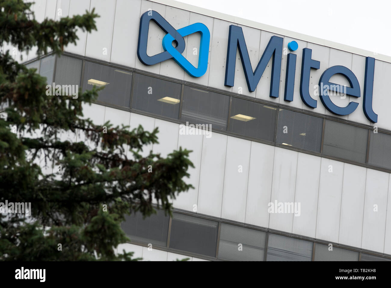 A logo sign outside of the headquarters of the Mitel Networks ...