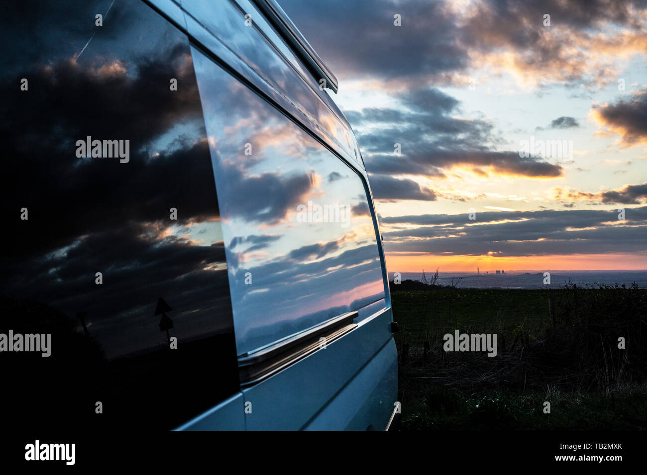 Reflections of clouds on camper van window at sunset Stock Photo - Alamy