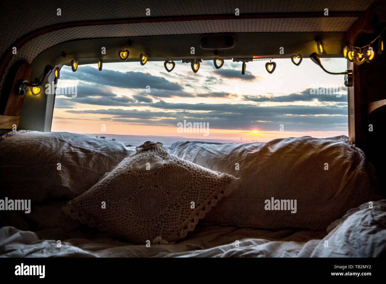 Camper van with cushion and fairy lights, view through rear window at ...