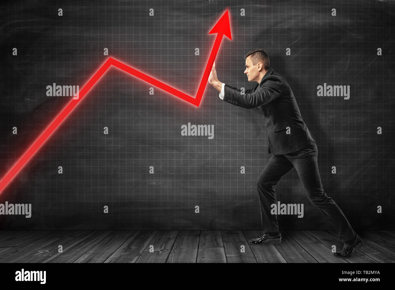 Side full length view of businessman pushing red graph arrow going up ...