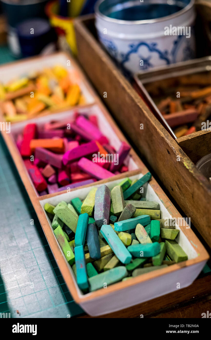 High angle close up of artist's crayons in a variety of vibrant colours ...