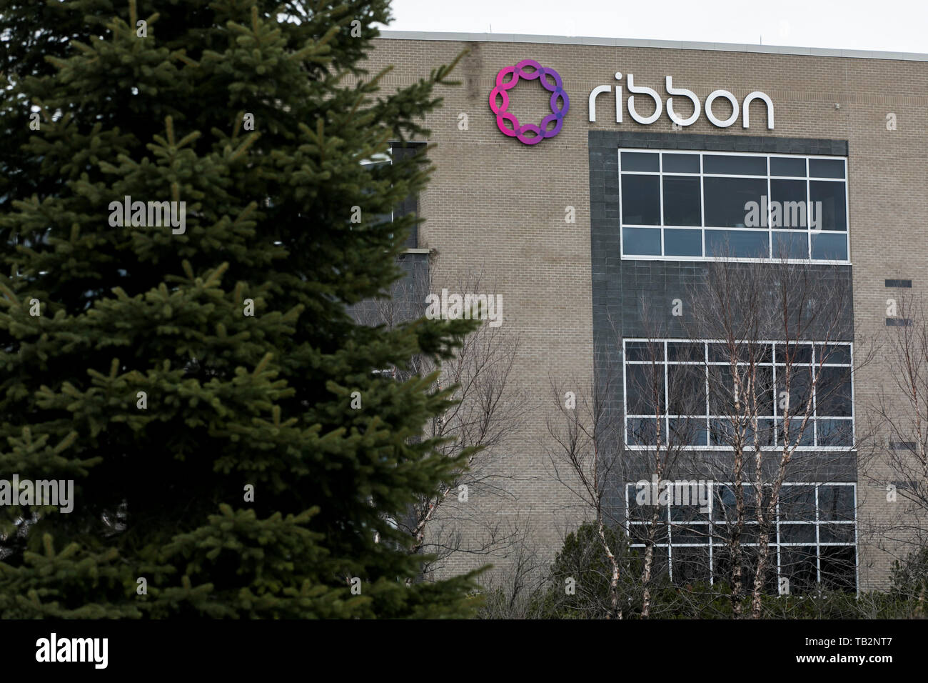 A logo sign outside of a facility occupied by Ribbon Communications in ...