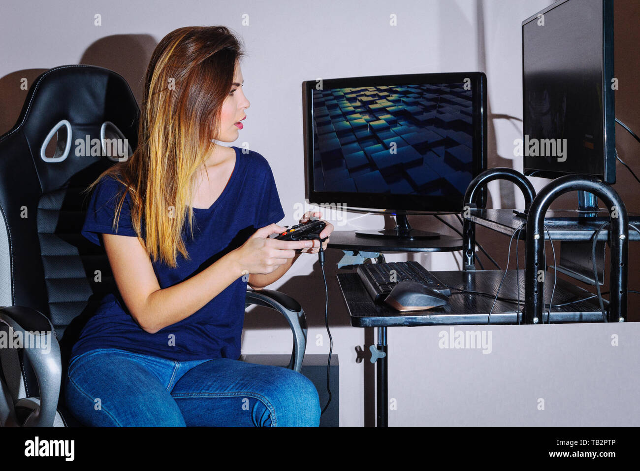 A young woman is playing a computer game Stock Photo - Alamy