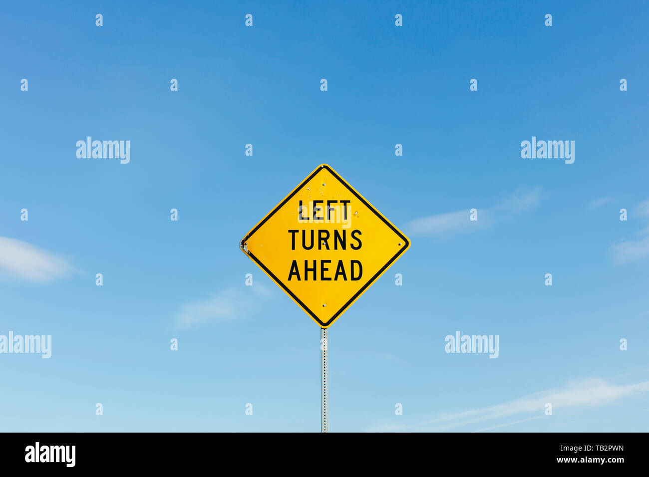 Left Turns Ahead yelloow traffic sign Stock Photo - Alamy