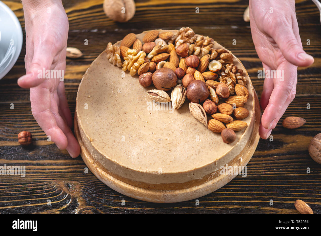 Nutty caramel cheesecake cake with topping of walnut, almond, hazelnut ...