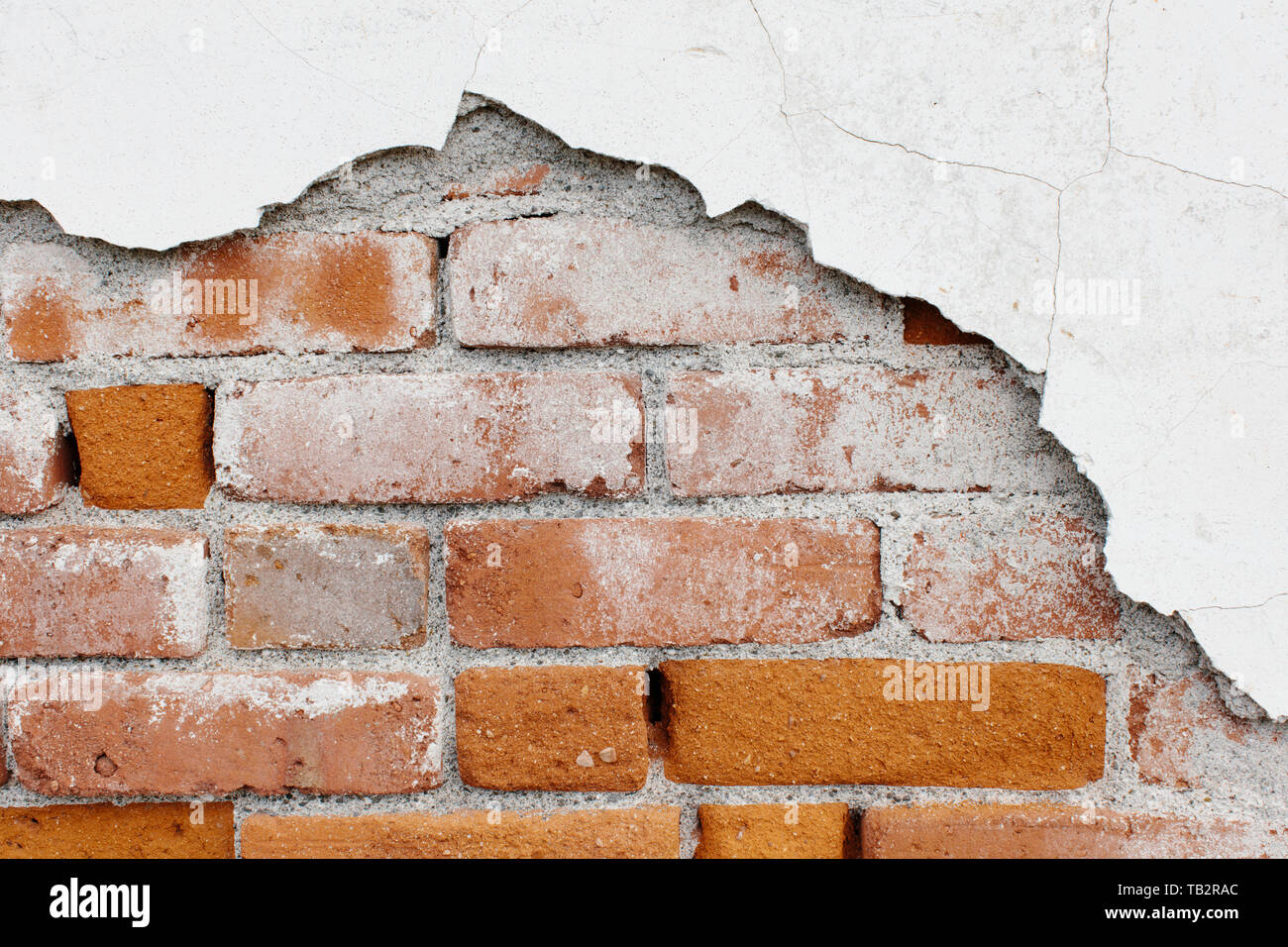 A brick wall and plasterwork flaking off Stock Photo - Alamy