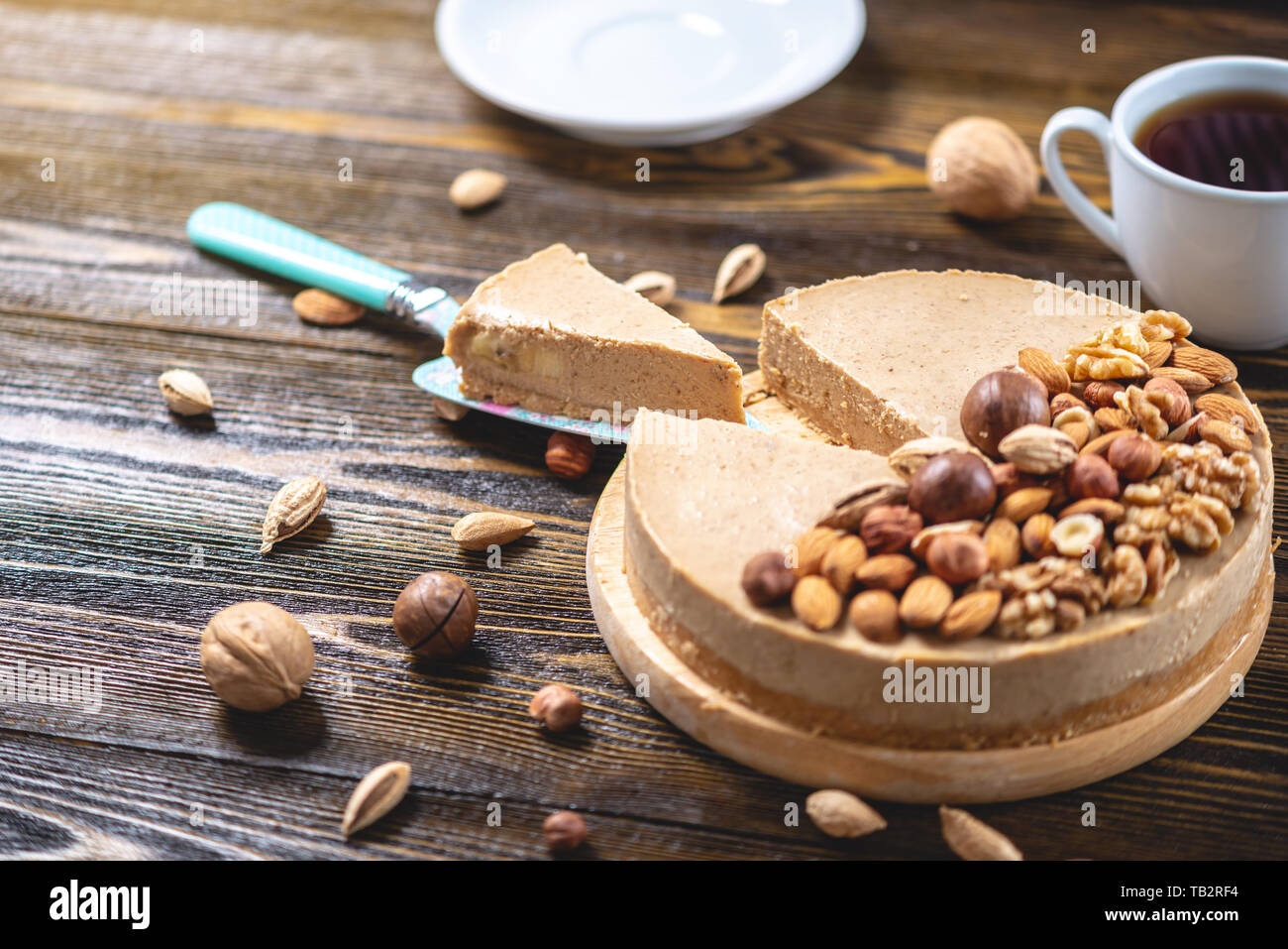Nutty caramel cheesecake cake with topping of walnut, almond, hazelnut ...
