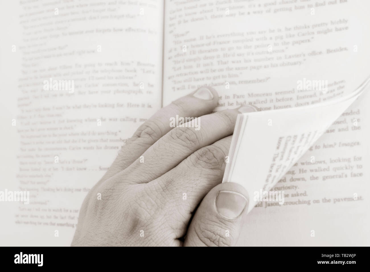 Close-up of hands turning the pages of an open book Stock Photo - Alamy