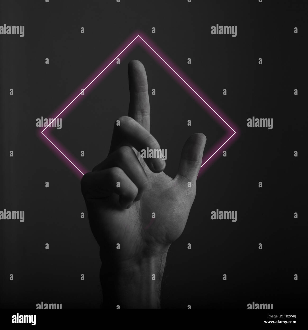 Hand pointing a finger against a dark background with abstract neon ...