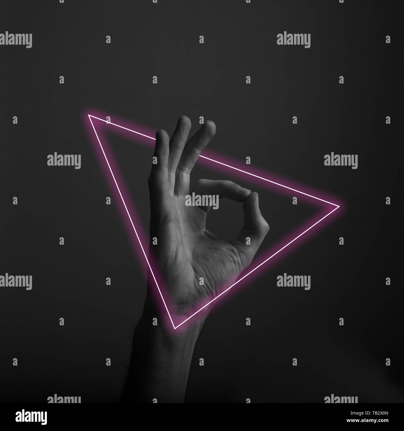 Close up of an okay hand gesture with abstract neon light glow. Ok hand ...