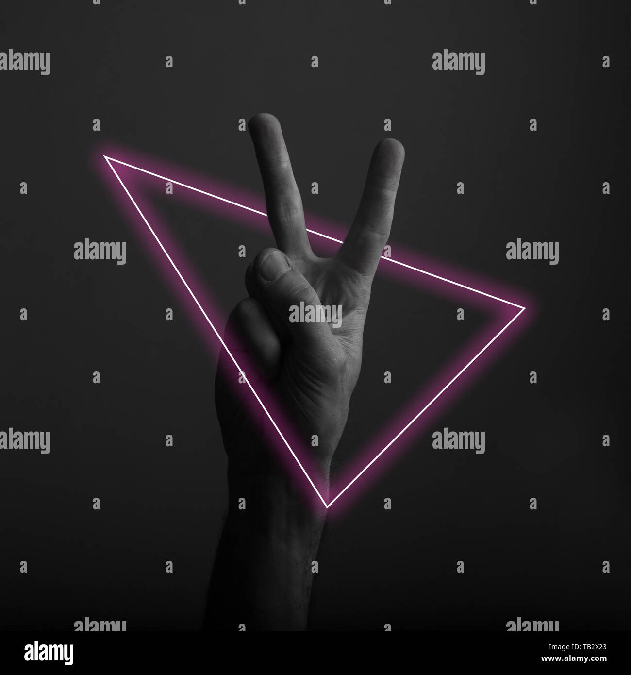 Male hand showing victory V hand sign with abstract neon light glow ...