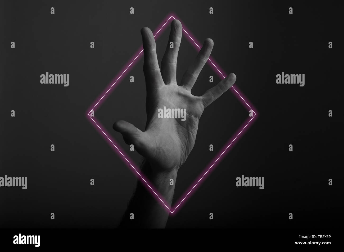 Male open hand gesture on a dark background with abstract neon light ...