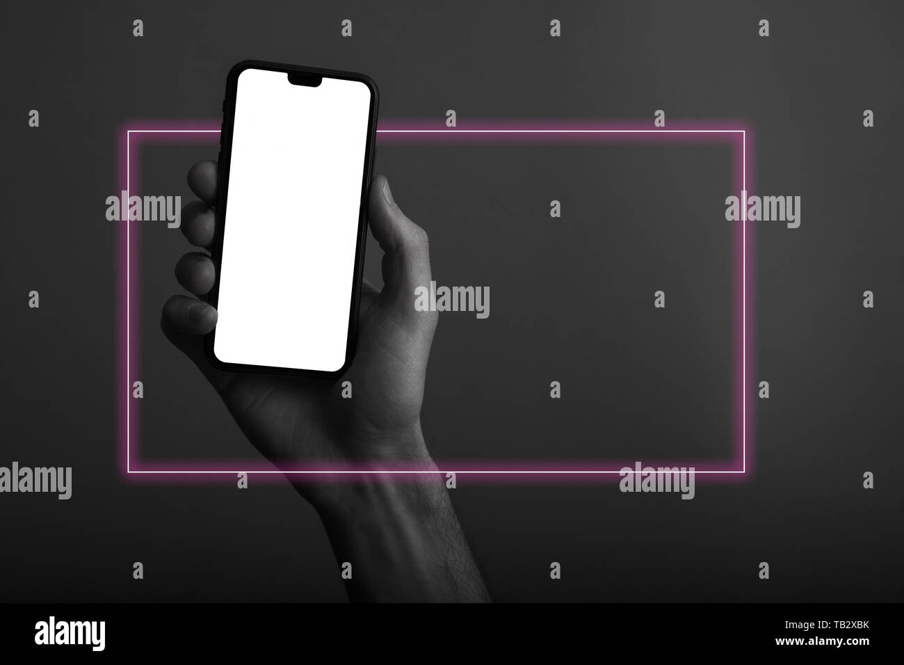 Hand holding modern smartphone with a blank white screen and neon light ...