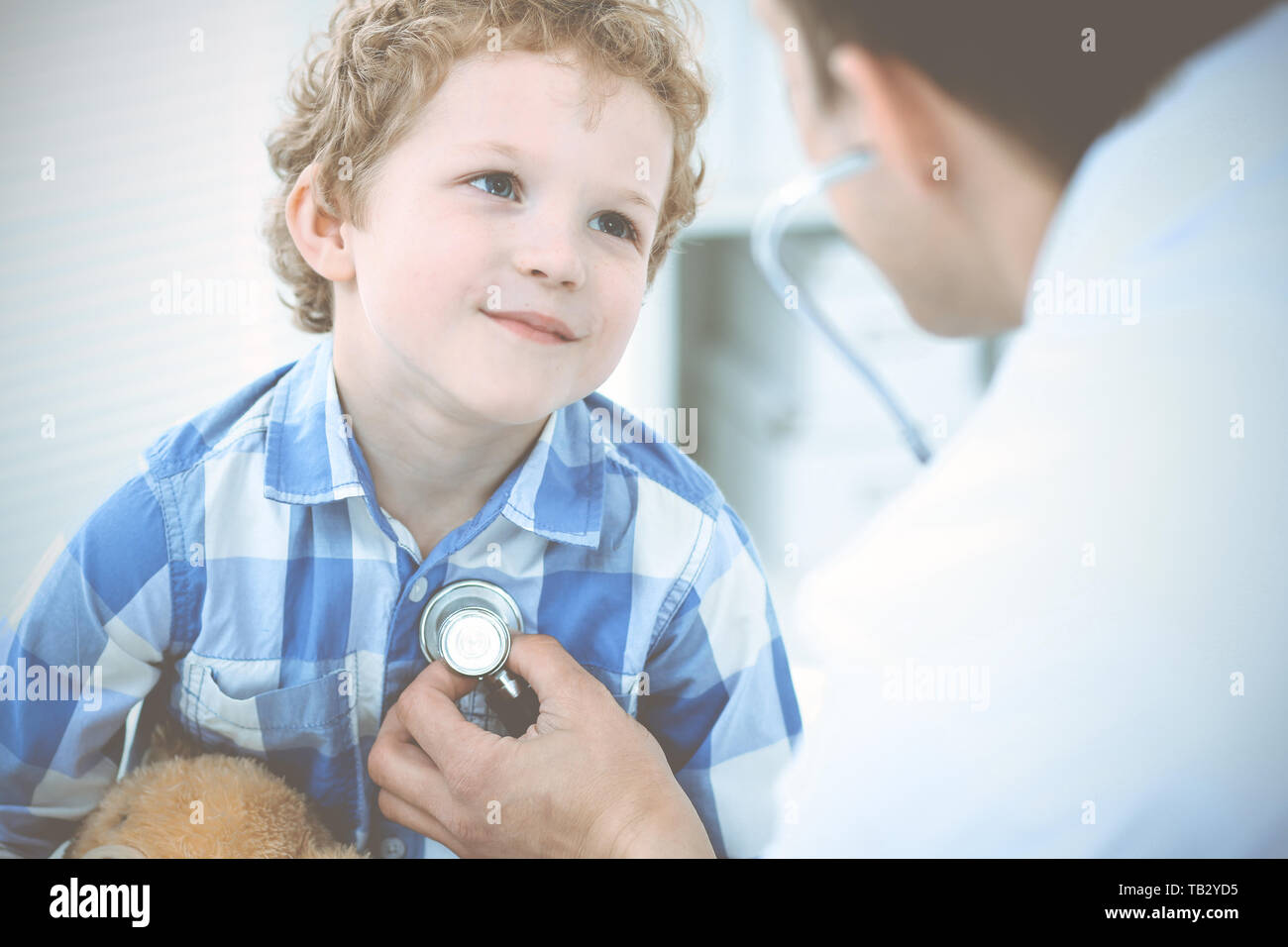 Doctor and patient child. Physician examining little boy. Regular ...