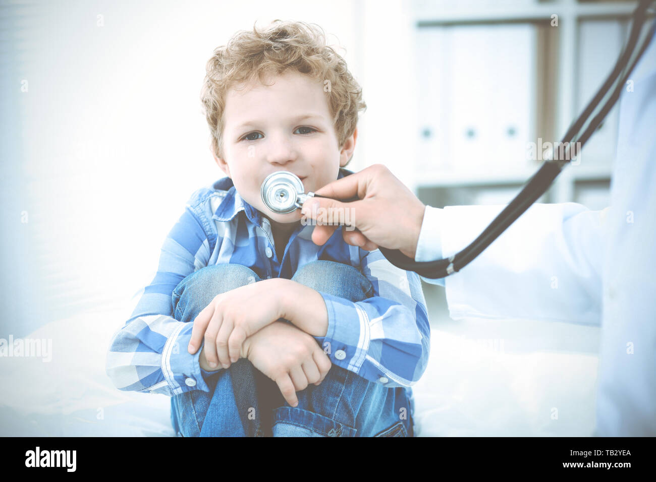 Doctor and patient child. Physician examining little boy. Regular ...