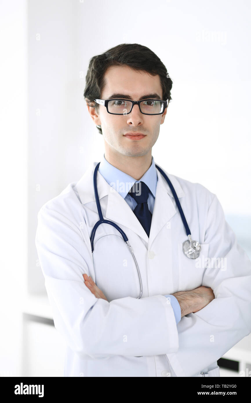 Doctor man standing straight with arms crossed. Perfect medical service ...