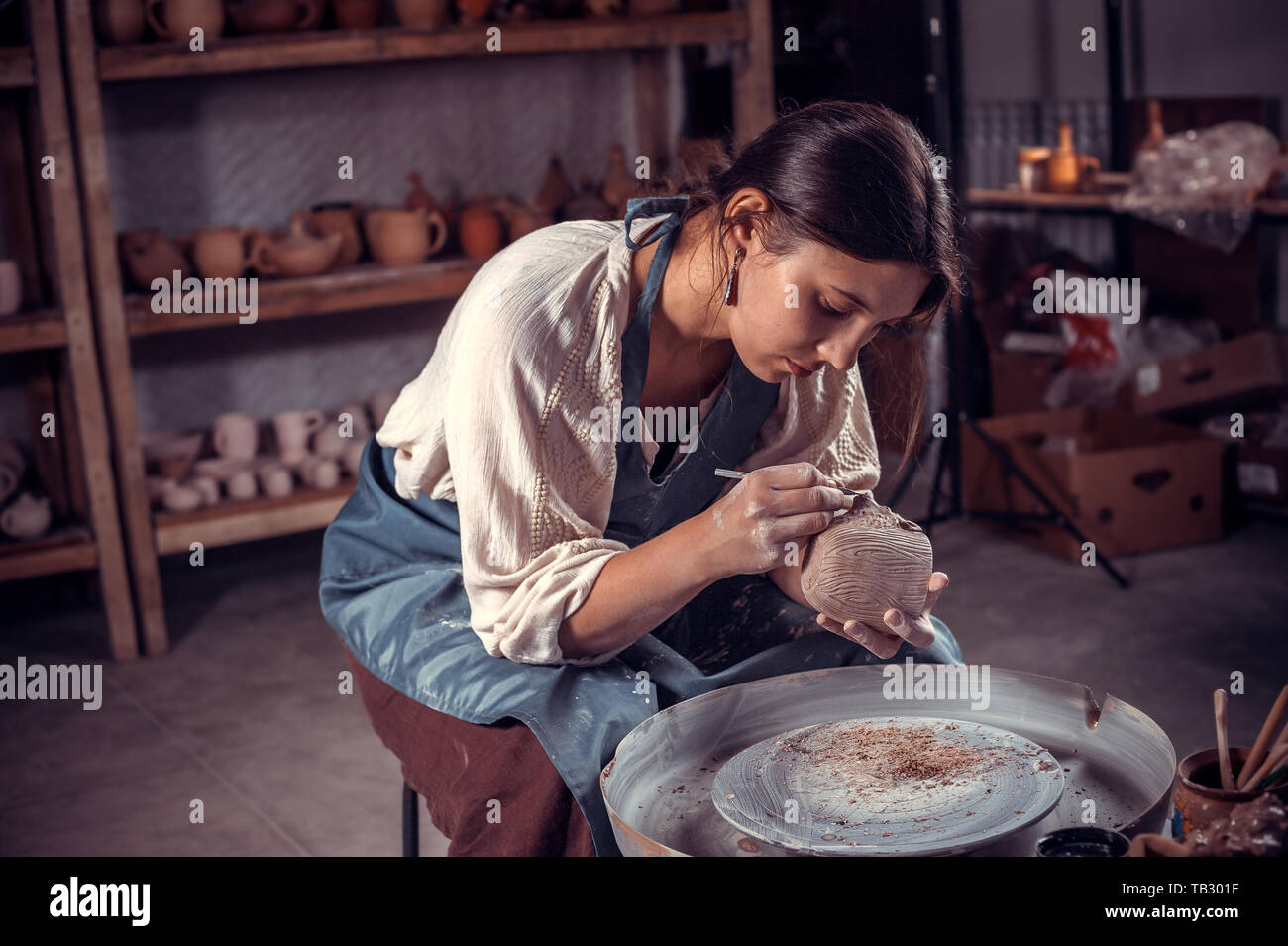 Beautifulhandicraftsman demonstrates the process of making ceramic ...