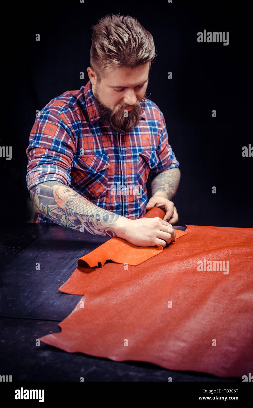 Leather master performs leather working for a new product Stock Photo ...