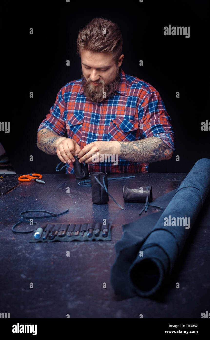 Tanner of leather creating a new leather product at the studio Stock ...