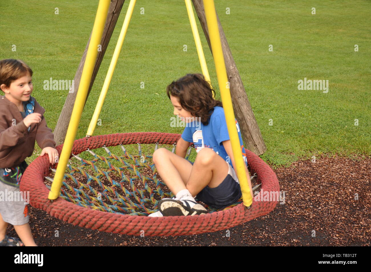 Two children playing in a playground Stock Photo - Alamy