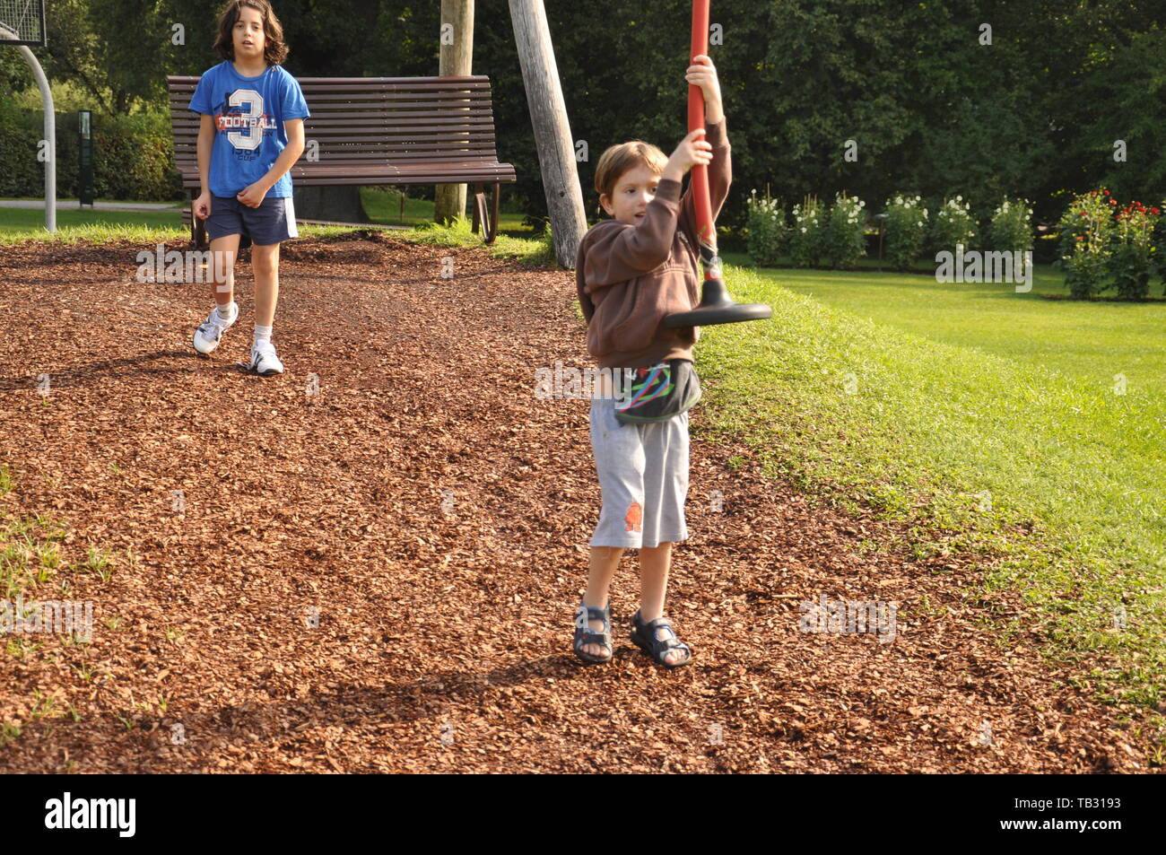 Two children playing in a playground Stock Photo - Alamy
