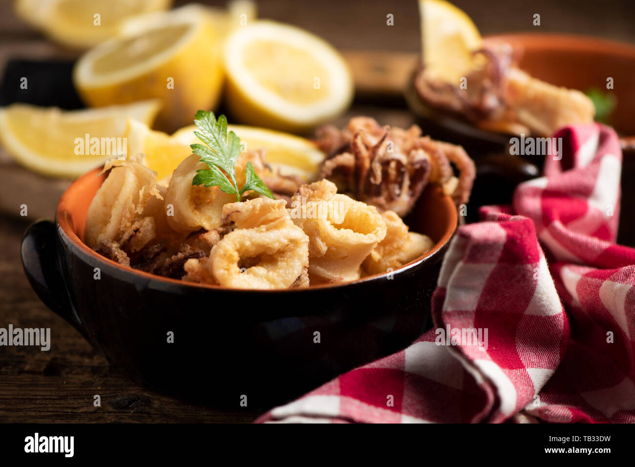 Traditional Italian fried calamari and lemon slice close up Stock Photo ...