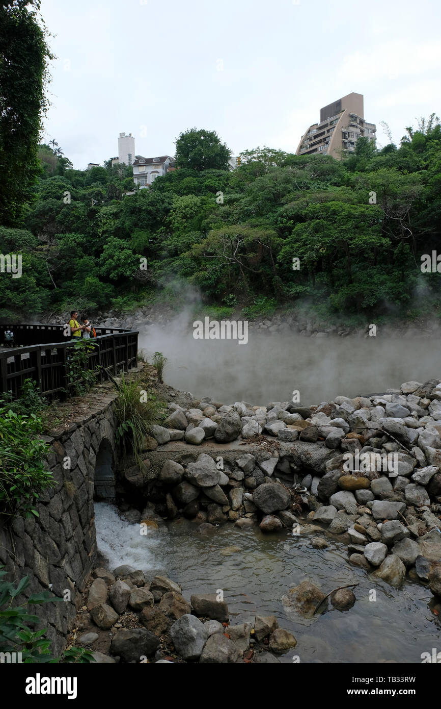 Clouds of sulfuric steam rising up from pool of scalding sulfur hot ...