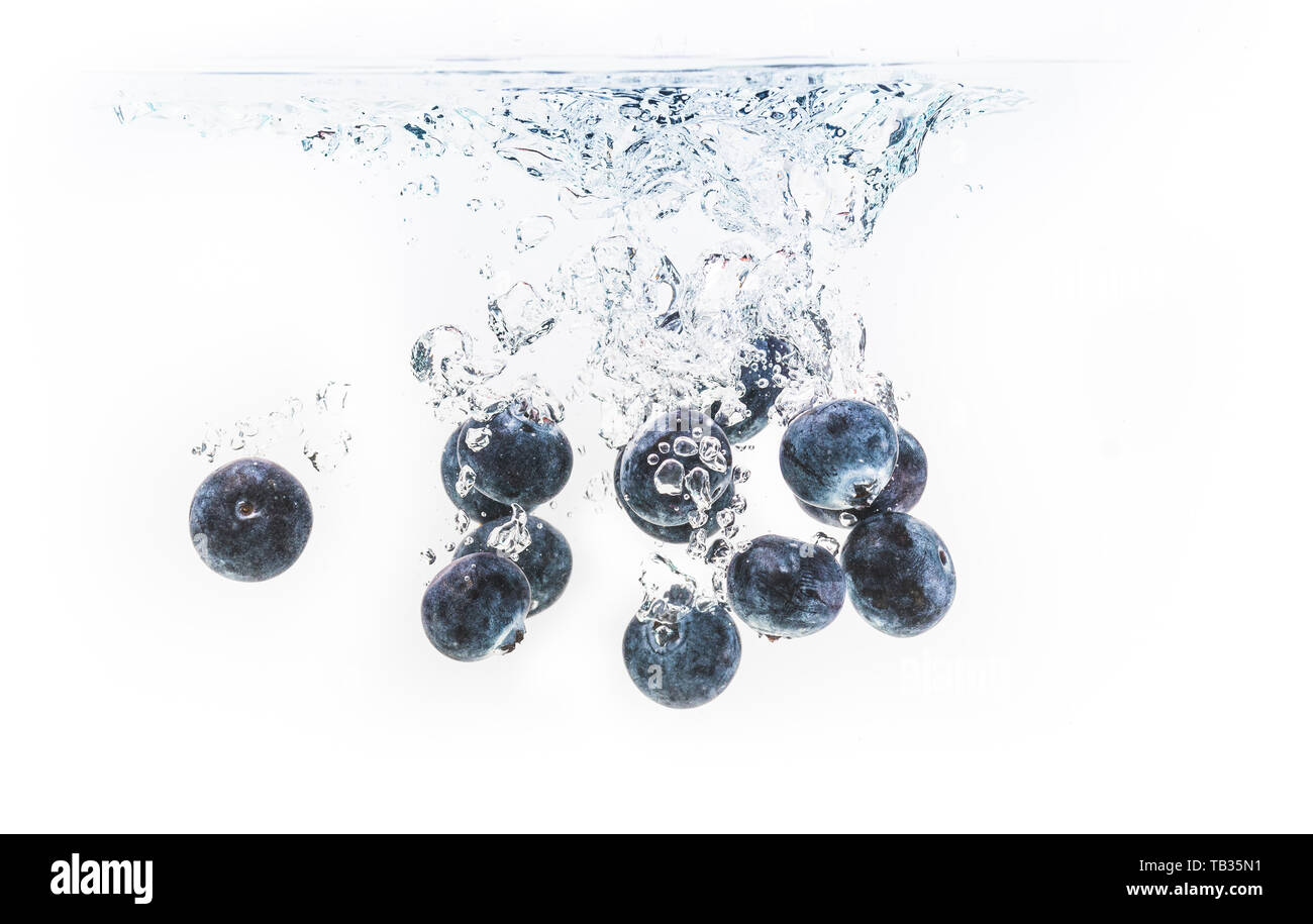Organic Blueberries sinking into water with air bubbles white ...