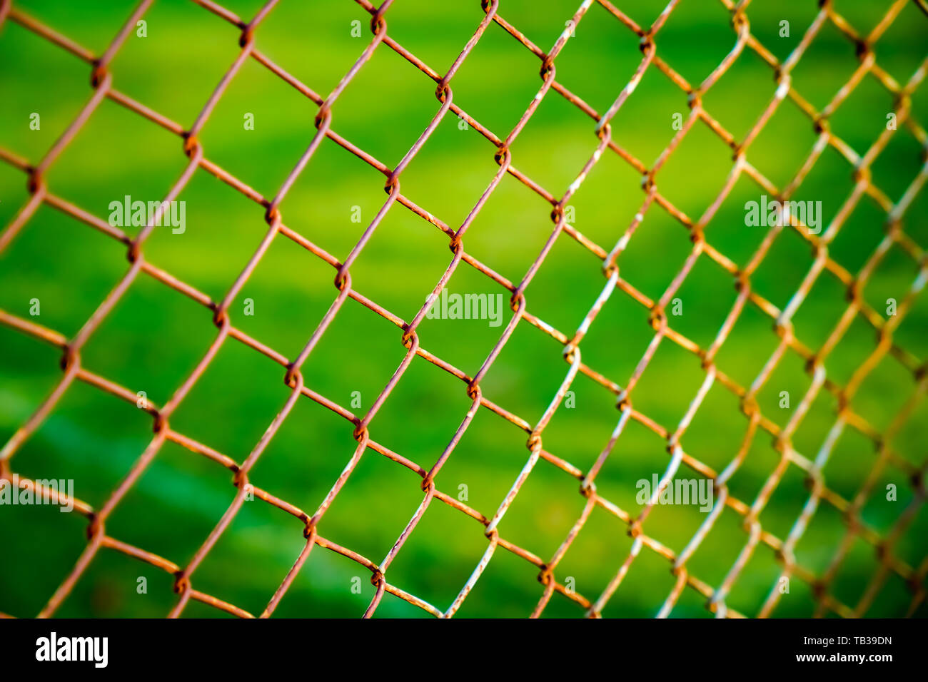 Rust steel net with blur football field Stock Photo - Alamy