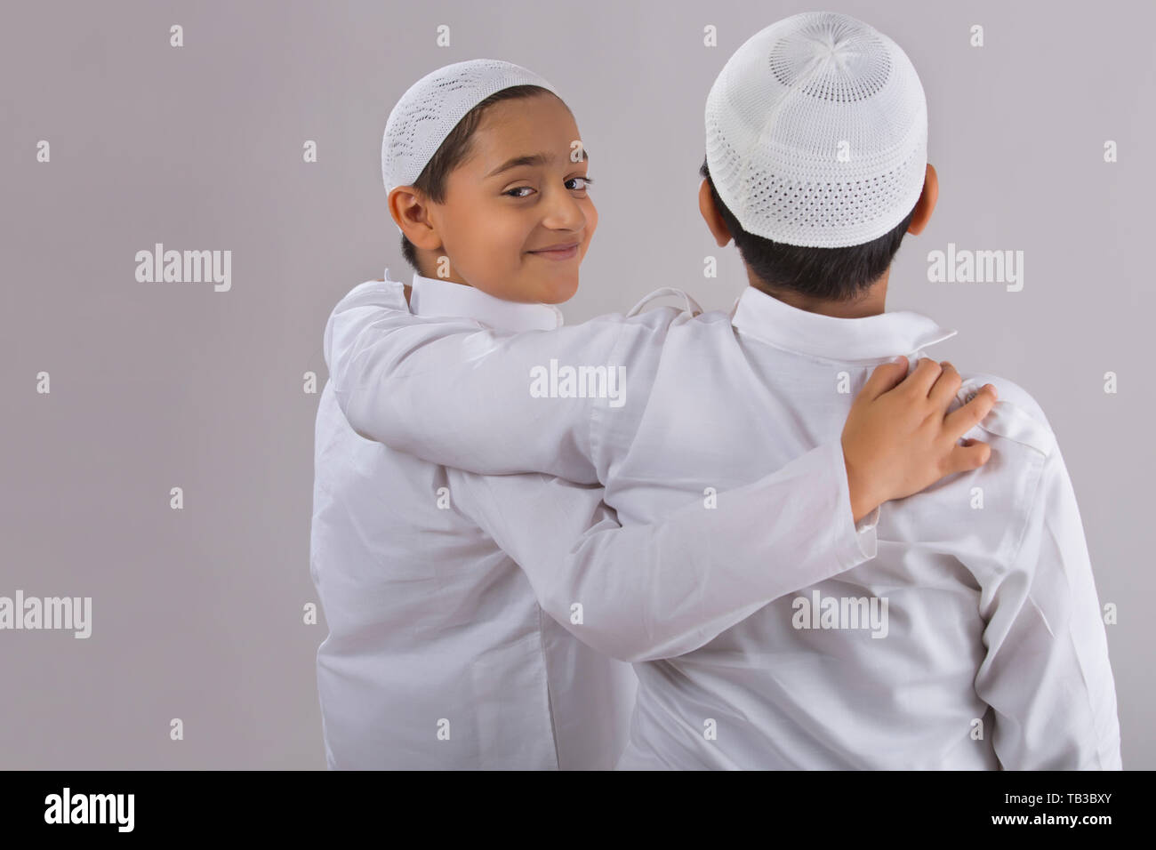 One young Muslim boy looking back and backside of other Stock Photo - Alamy