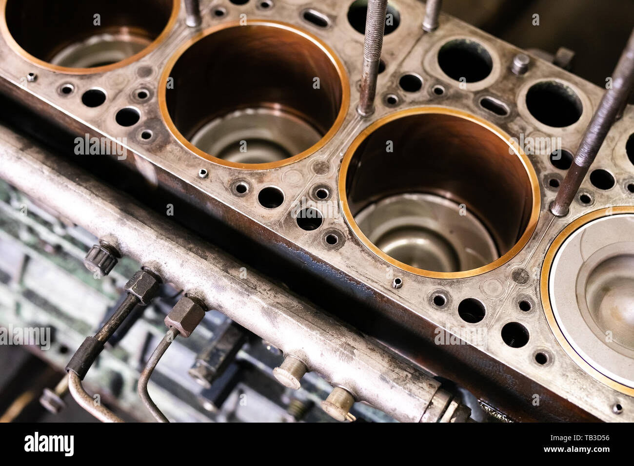 Mechanic repairs old motor of truck in a car repair station ...