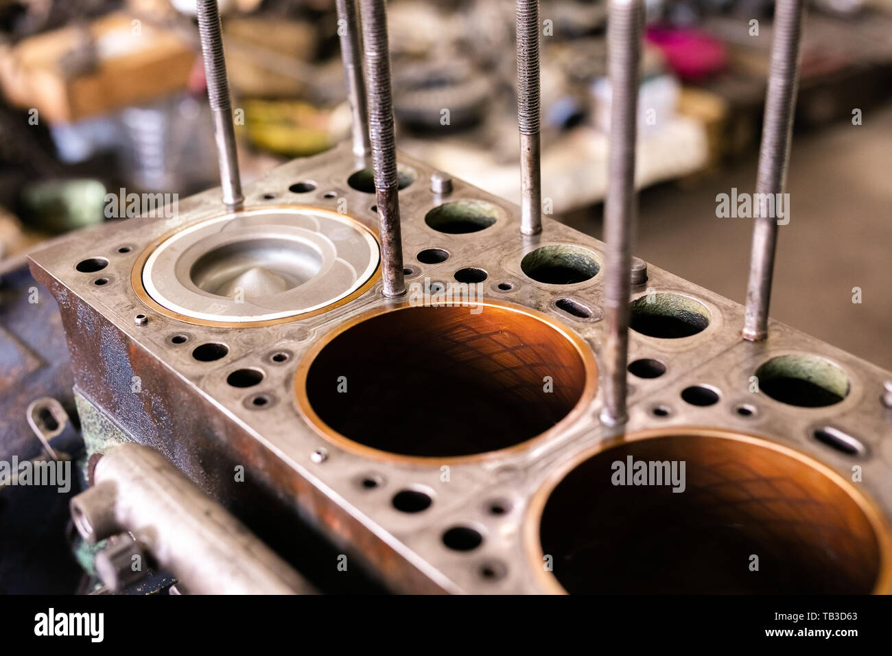 Mechanic repairs old motor of truck in a car repair station ...