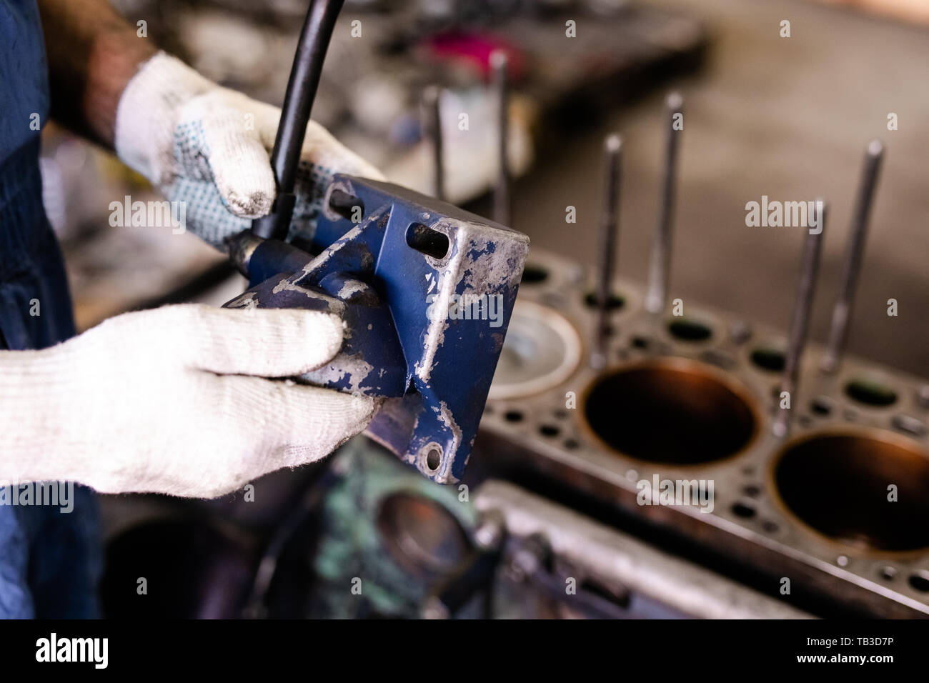 Mechanic repairs old motor of truck in a car repair station ...