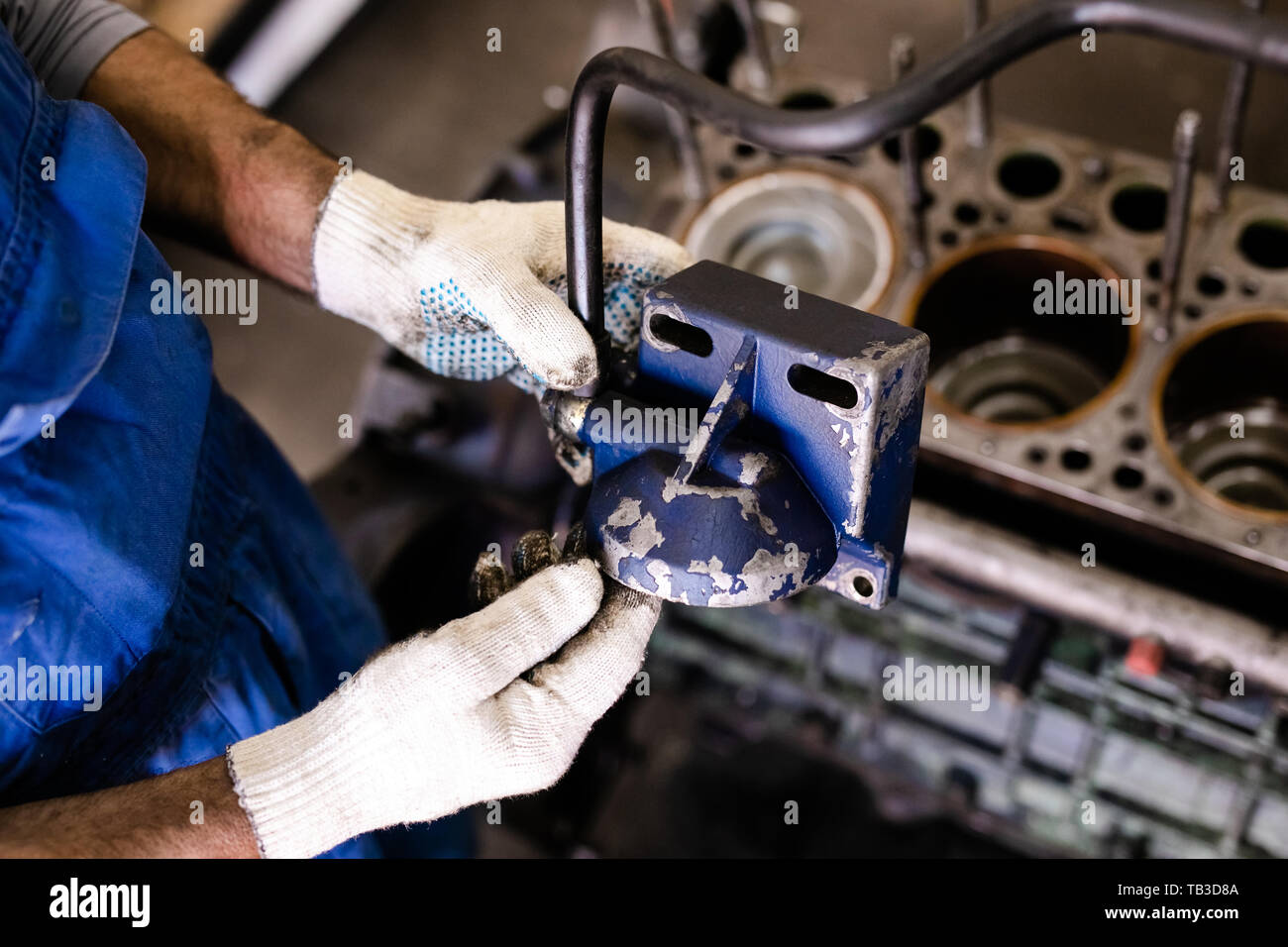 Mechanic repairs old motor of truck in a car repair station ...